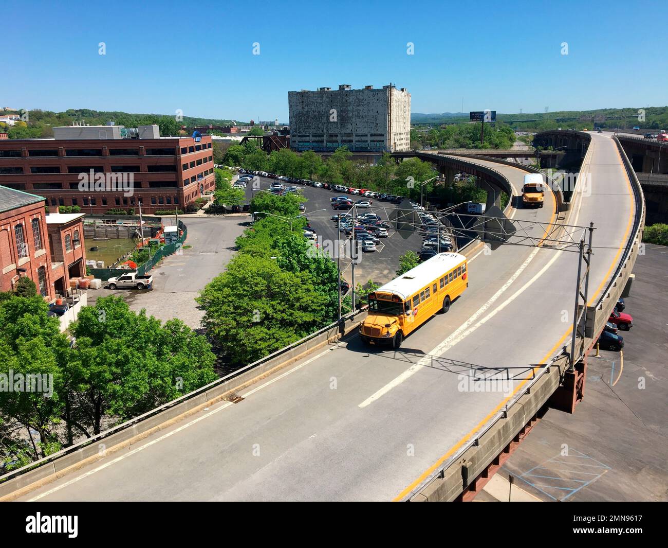 In this May 21, 2018, photo, school buses drive along a highway ramp ...