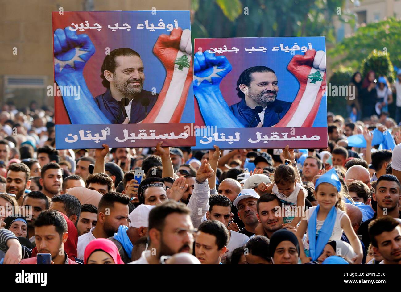 Supporters of Lebanese Prime Minister Saad Hariri, hold posters with ...