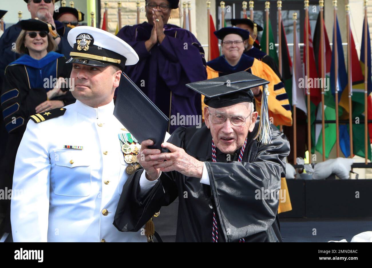 World War II veteran Bob Barger holds his diploma at the commencement ...
