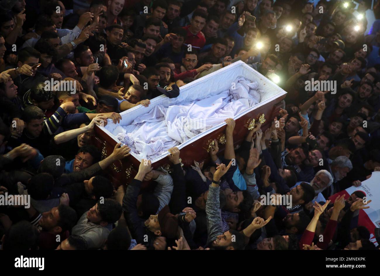 Mourners chant slogans while carry the coffin of Palestinian scientist ...