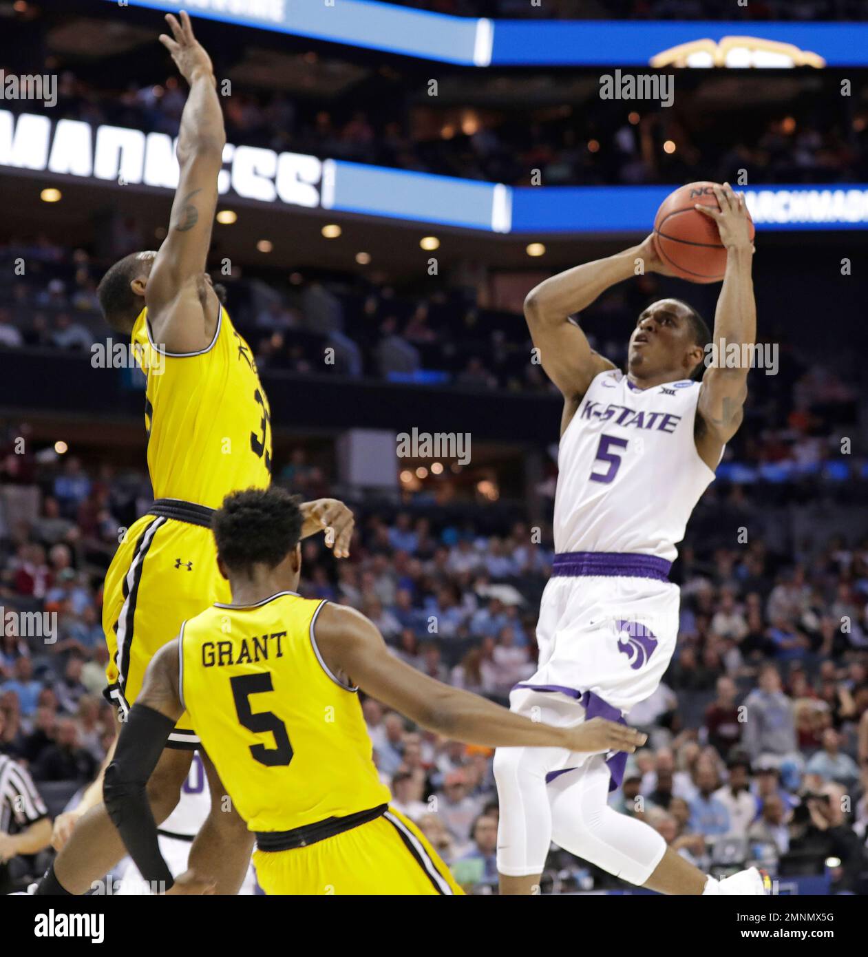 Kansas State's Barry Brown, right, drives against UMBC's Jourdan Grant ...
