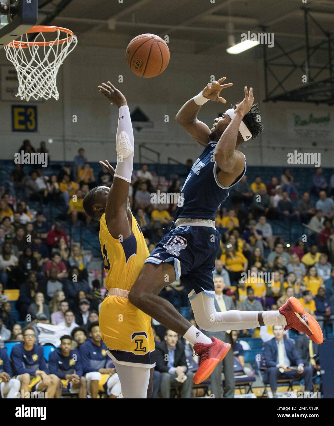 Rhode Island's E.C. Matthews, right, goes up for the shot against La ...