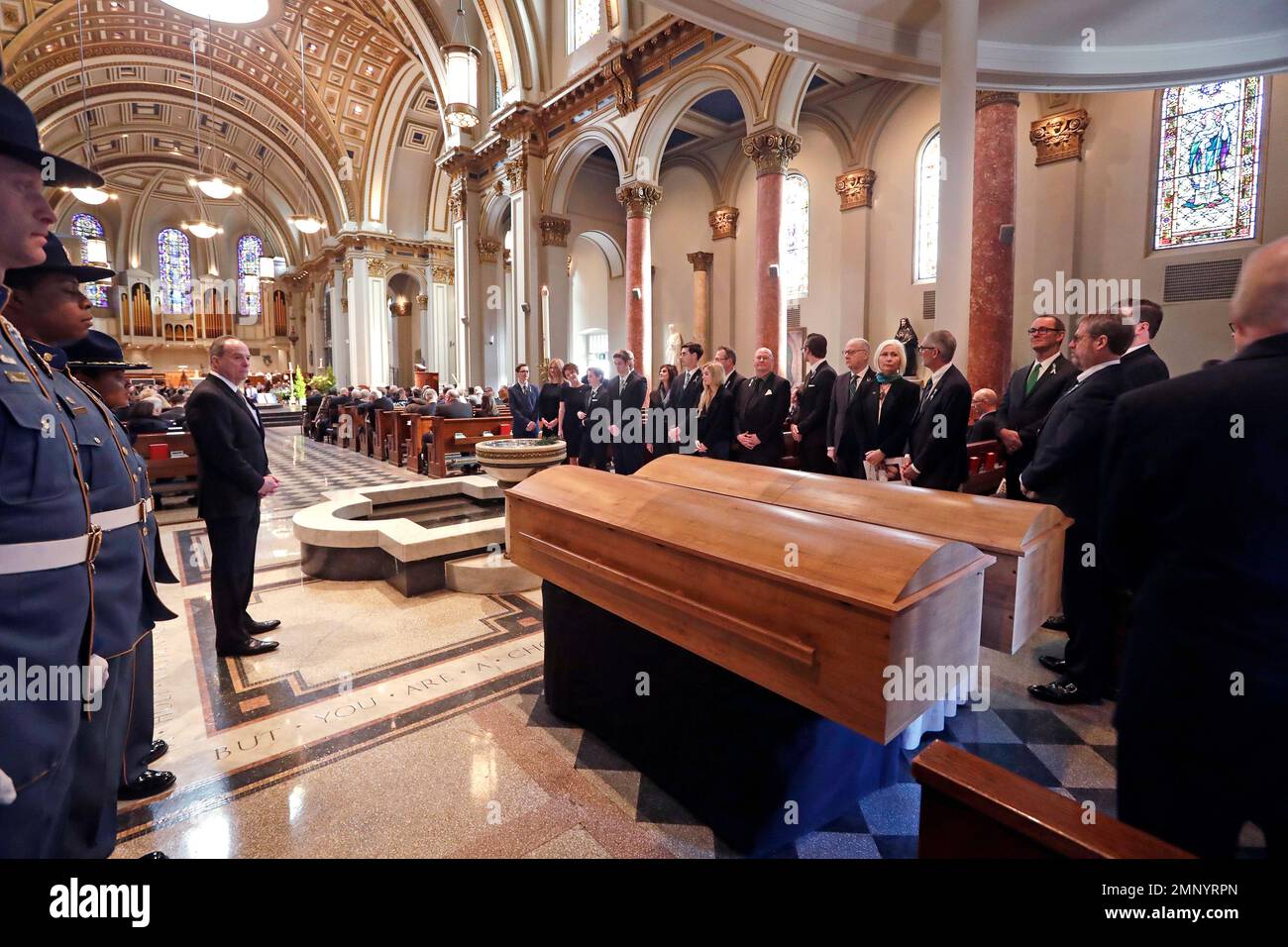 A Washington State Patrol honor guard, left, stands ready to move the ...