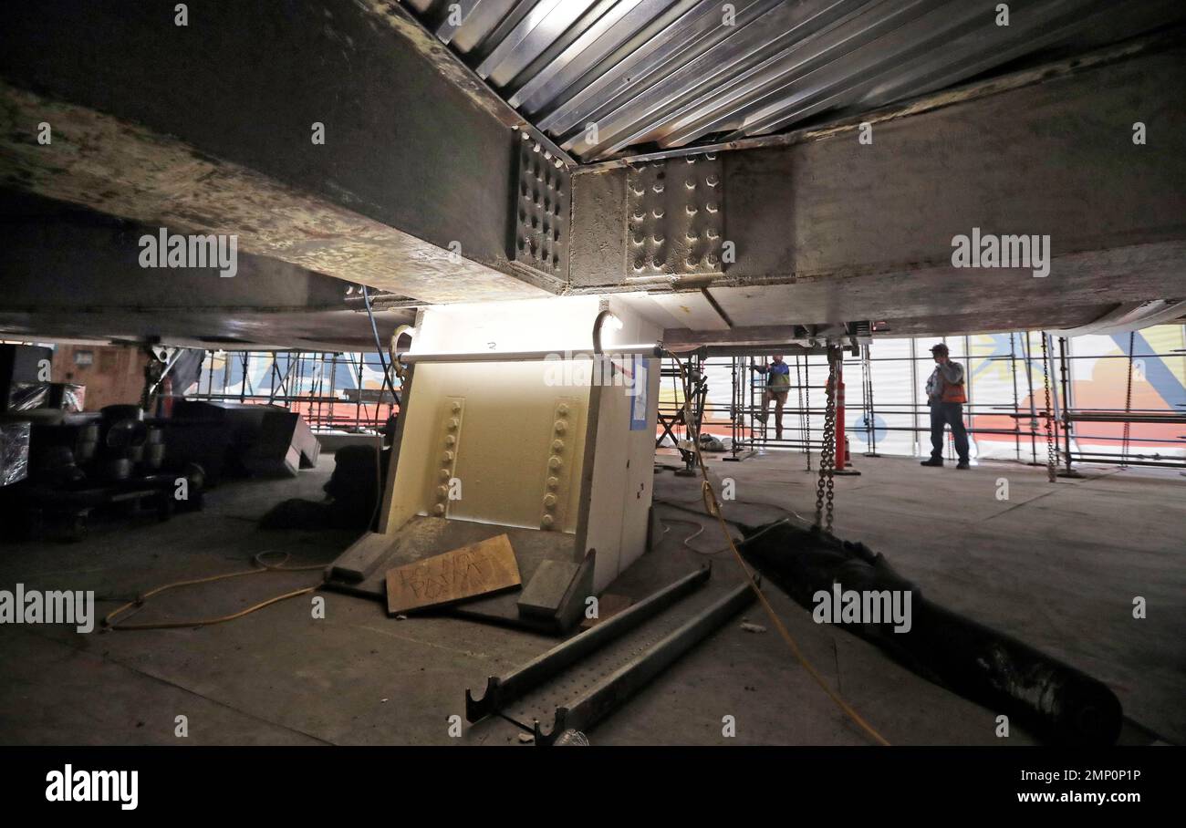 Workers stand on a construction platform some 500-feet above ground ...