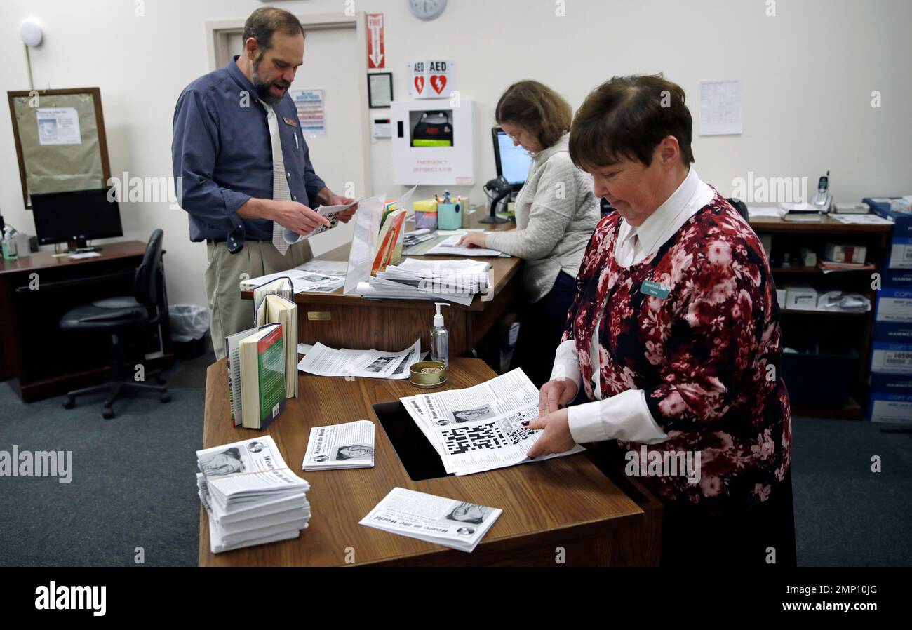 Librarian Thelma Tracy, right, folds editions of the "Weare in the ...