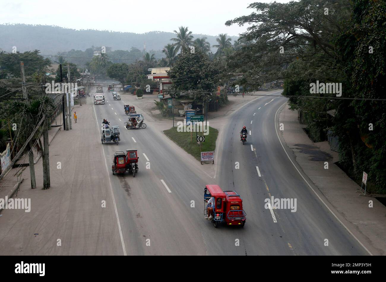 Volcanic ash from Mayon volcano's eruption is seen along a highway in ...