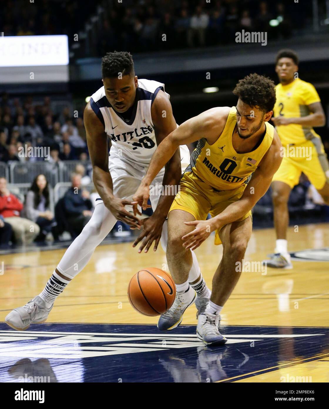 Butler forward Kelan Martin, left, goes after a loose ball with ...