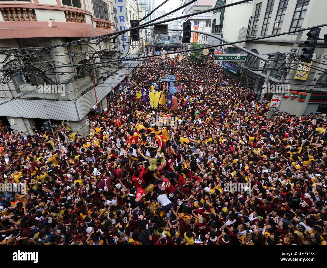 Filipino Roman Catholic devotees jostle to get near the image of the ...