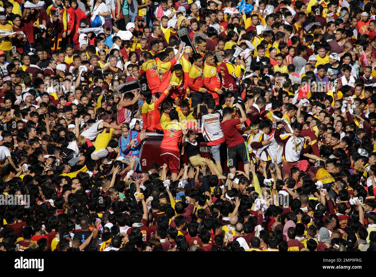 Filipino Roman Catholic devotees jostle for position during a raucous ...