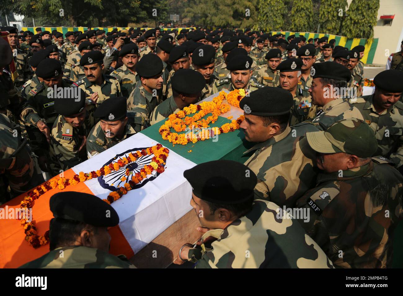Indian Border Security Force (BSF) officers carry the coffin of their ...