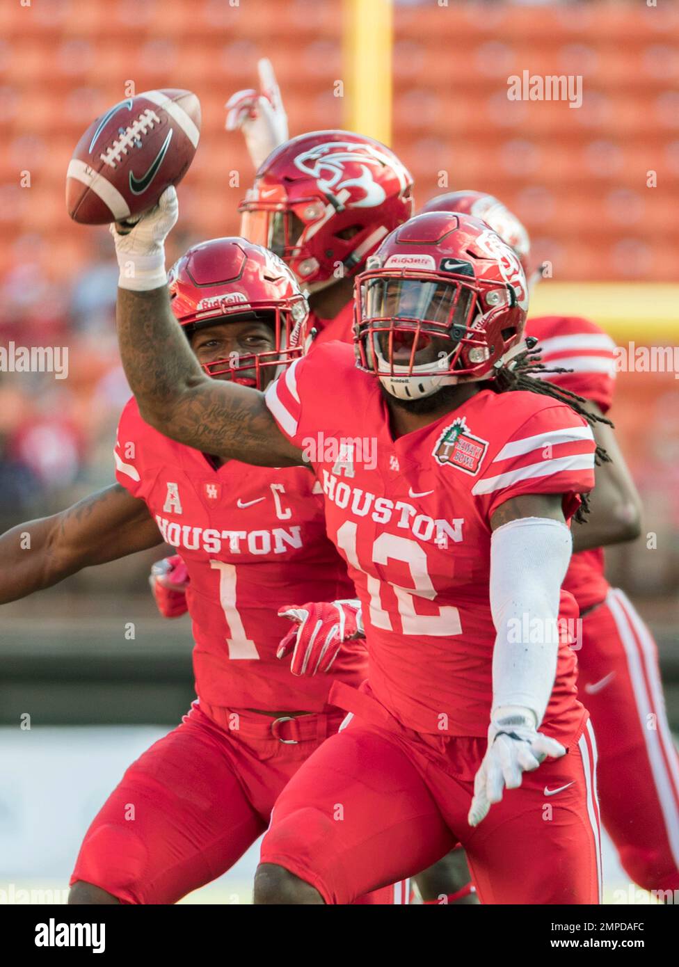 Houston linebacker D'Juan Hines (12) and his teammates celebrate the ...