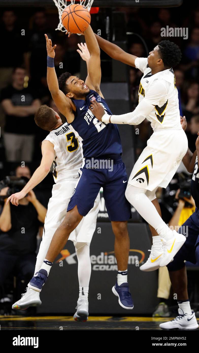 Penn State guard Josh Reaves, center, fights for a rebound with Iowa's ...