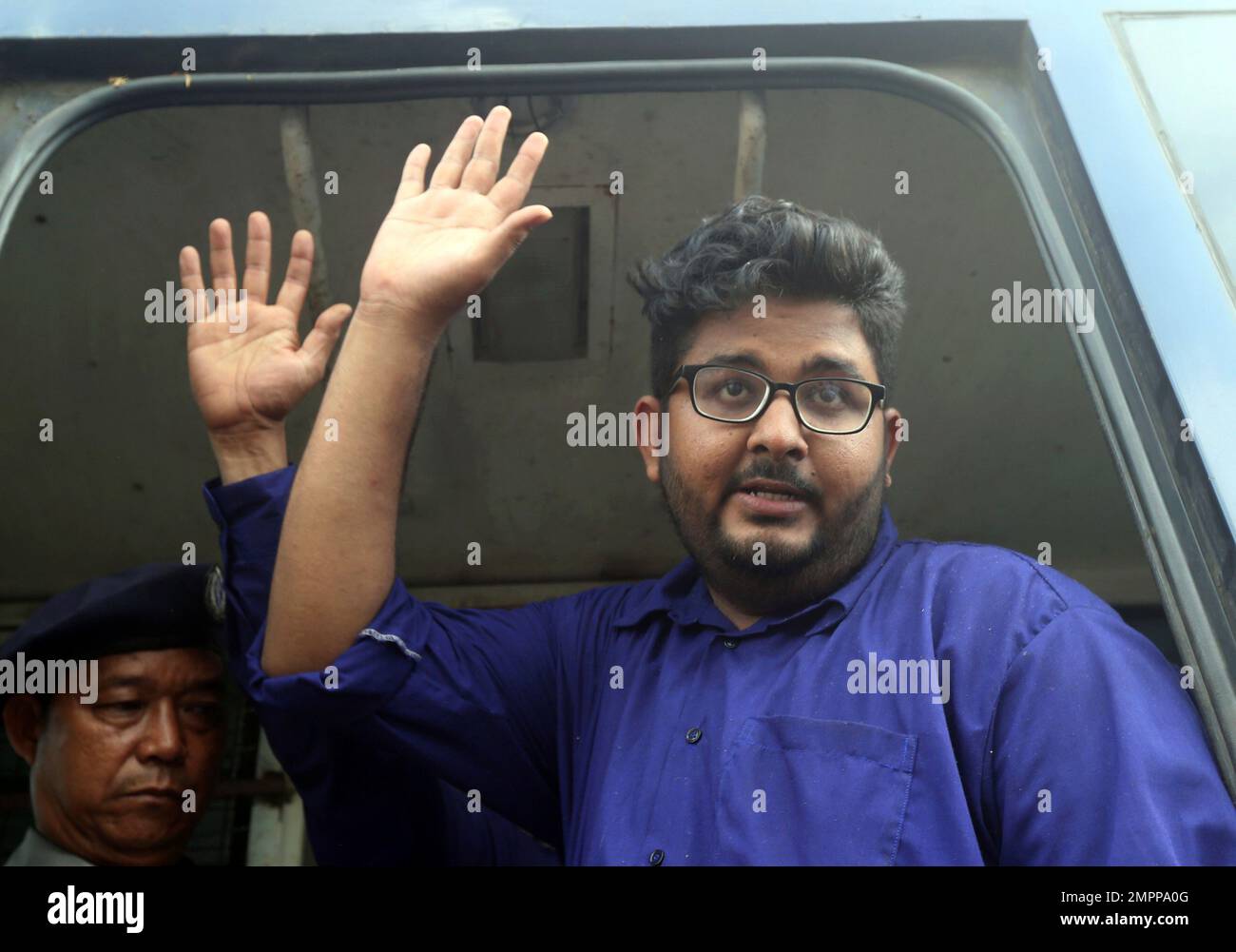 Myanmar local interpreter Aung Naing Soe, right, leaves after his trial ...