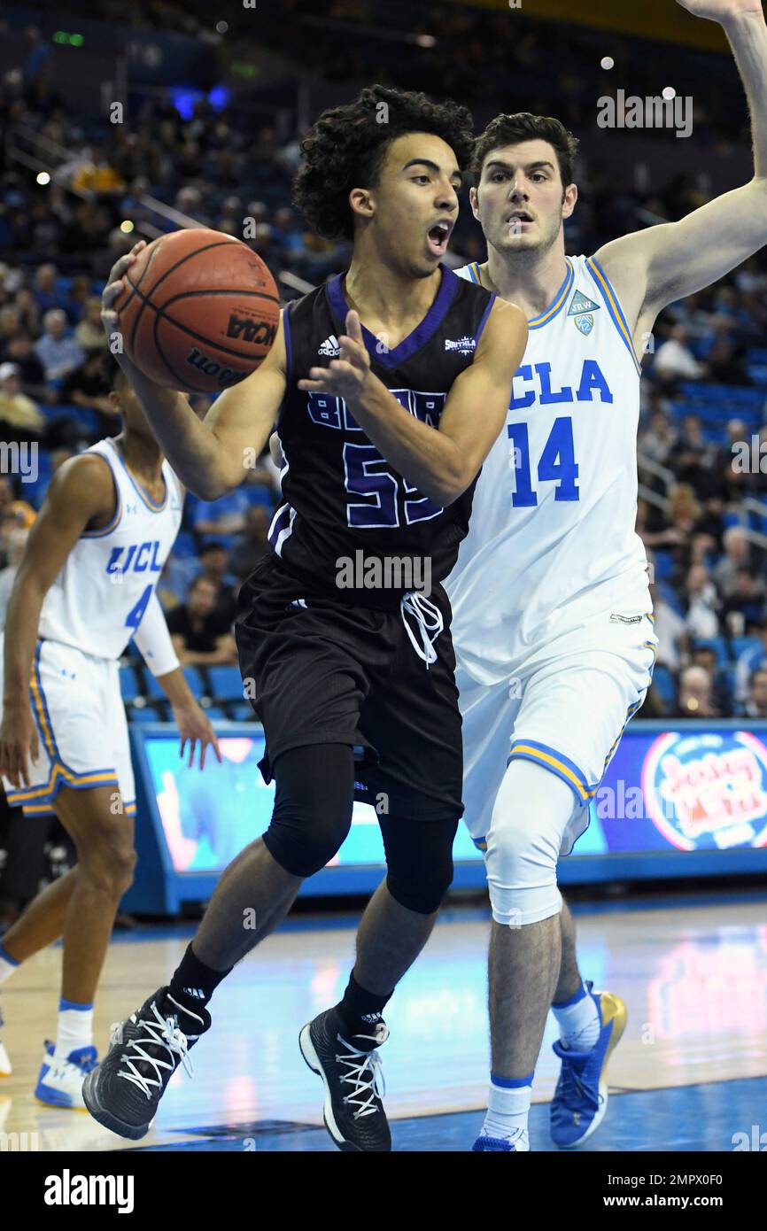 Central Arkansas guard DeAndre Jones, left, passes as UCLA's Gyorgy ...