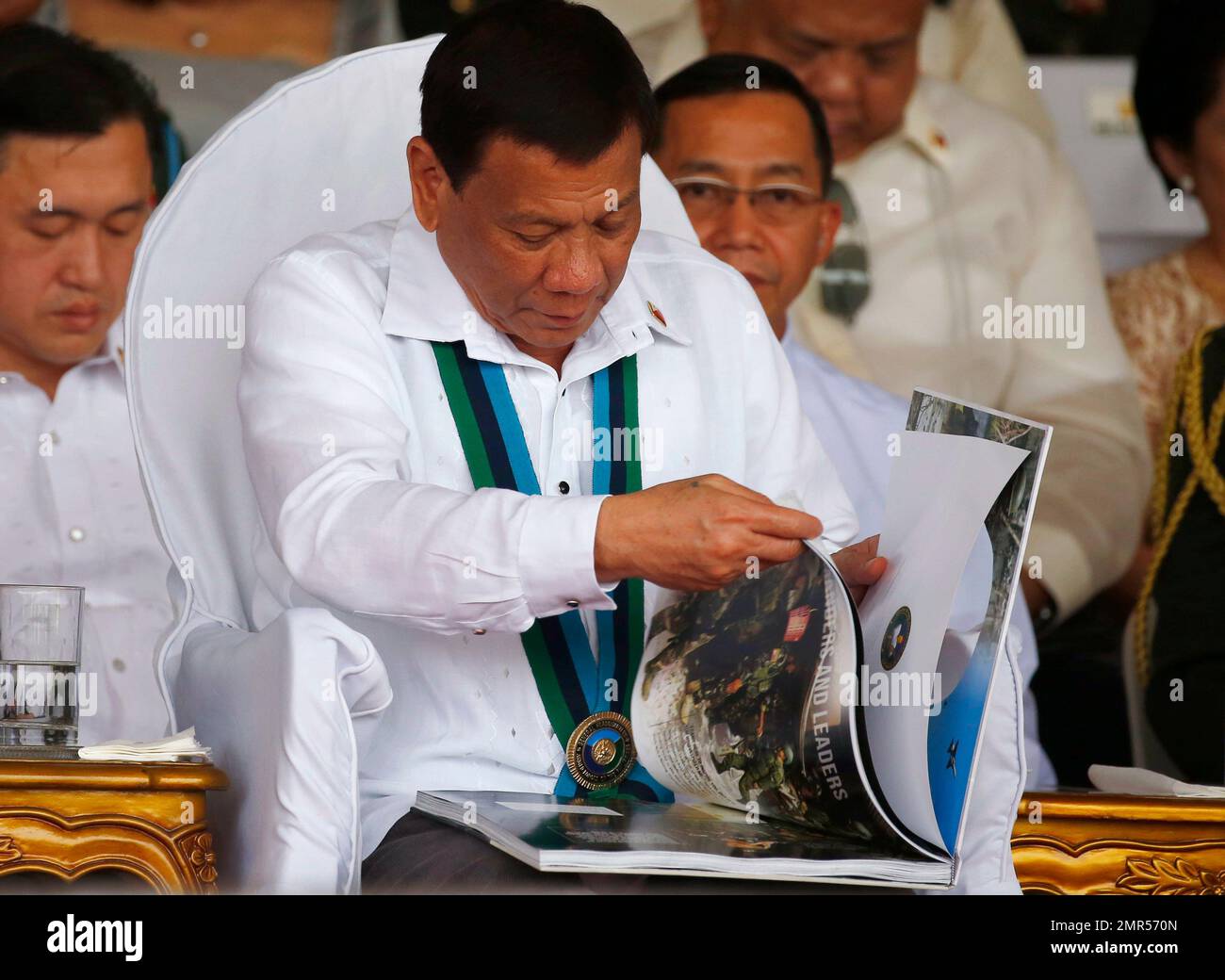 Philippine President Rodrigo Duterte scans the pages of a coffee table ...