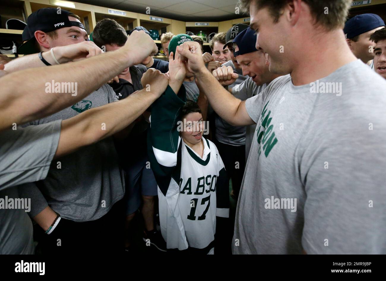 Coleman Walsh, 10, of Walpole, Mass., center, gathers with members the ...