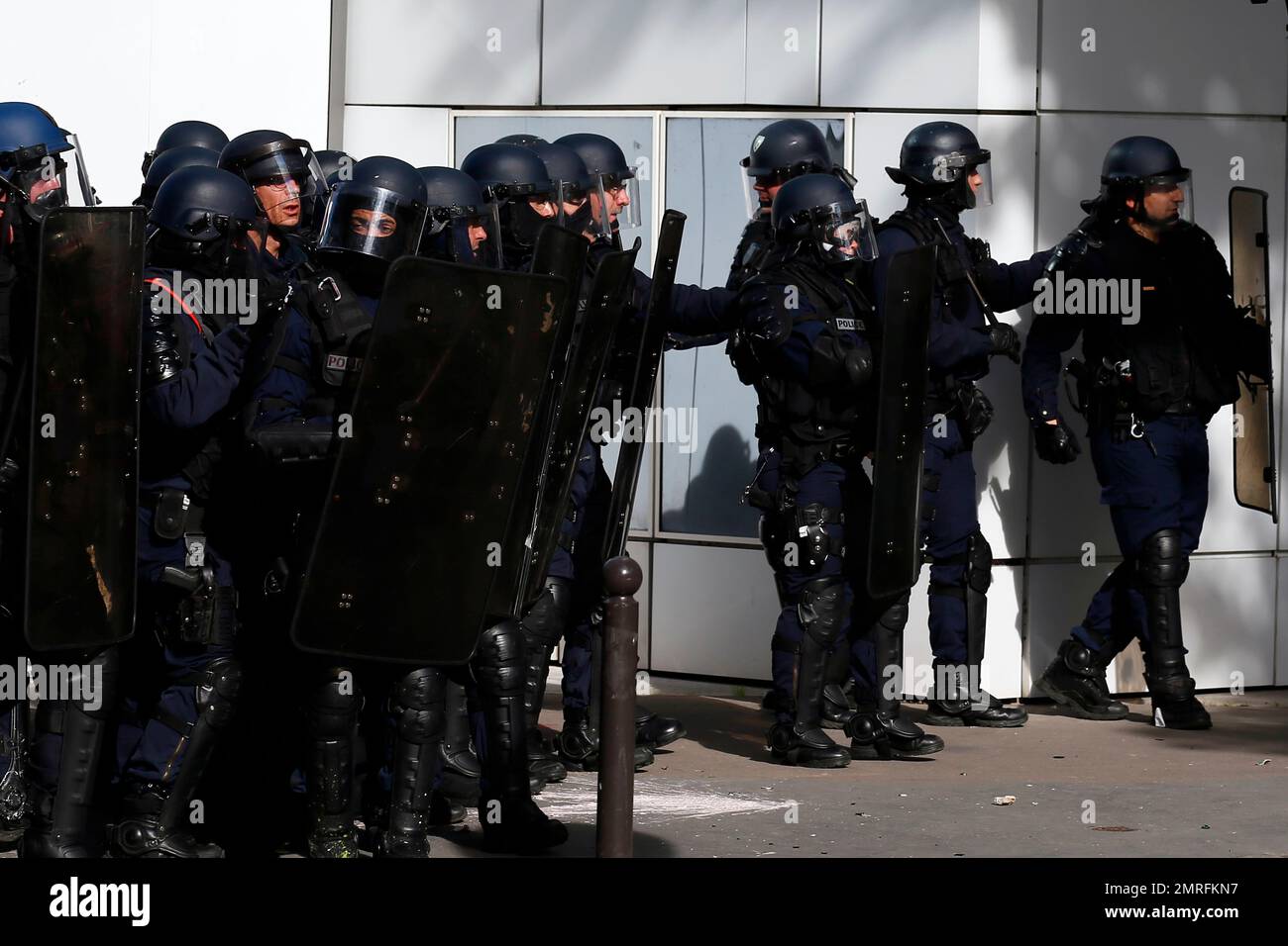 French riot police officers take position during a protest march ...