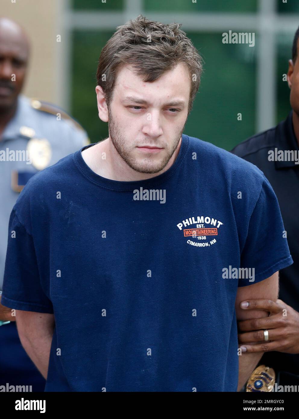 Kenneth James Gleason is escorted by police to a waiting police car in ...