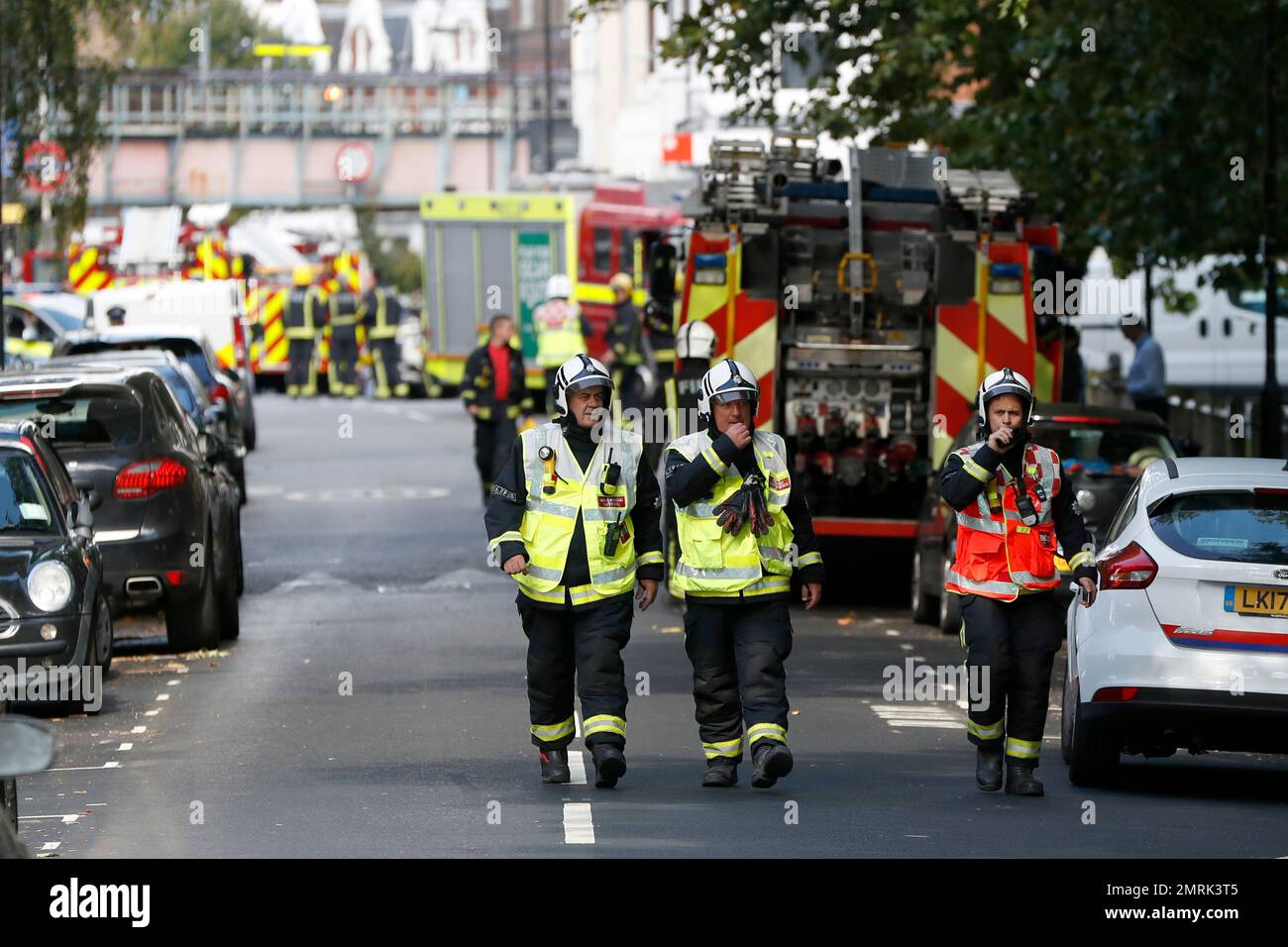Fire brigade officers walk within a cordon near where an incident ...