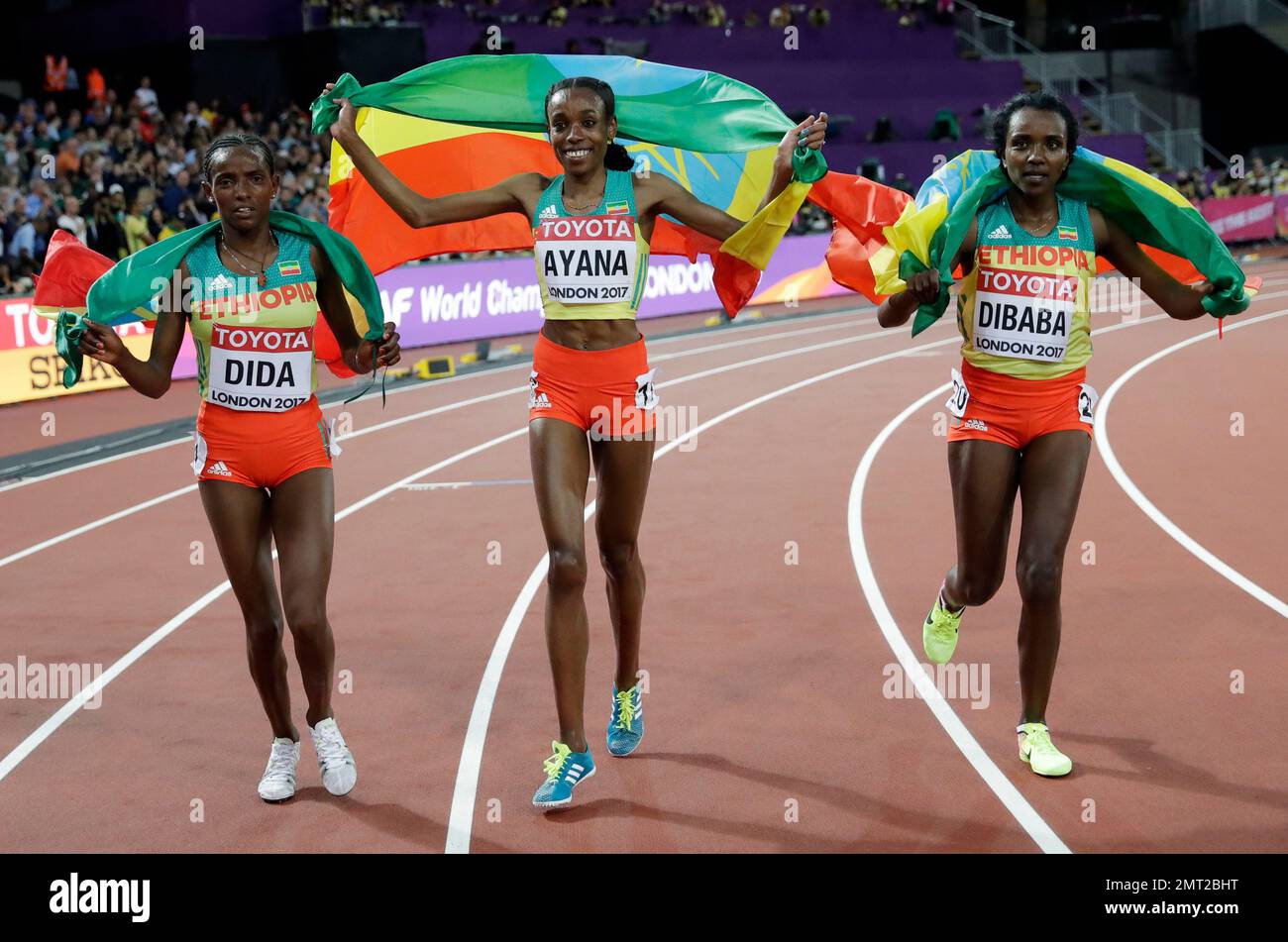 Ethiopia's gold medal winner Almaz Ayana is accompanied by her ...