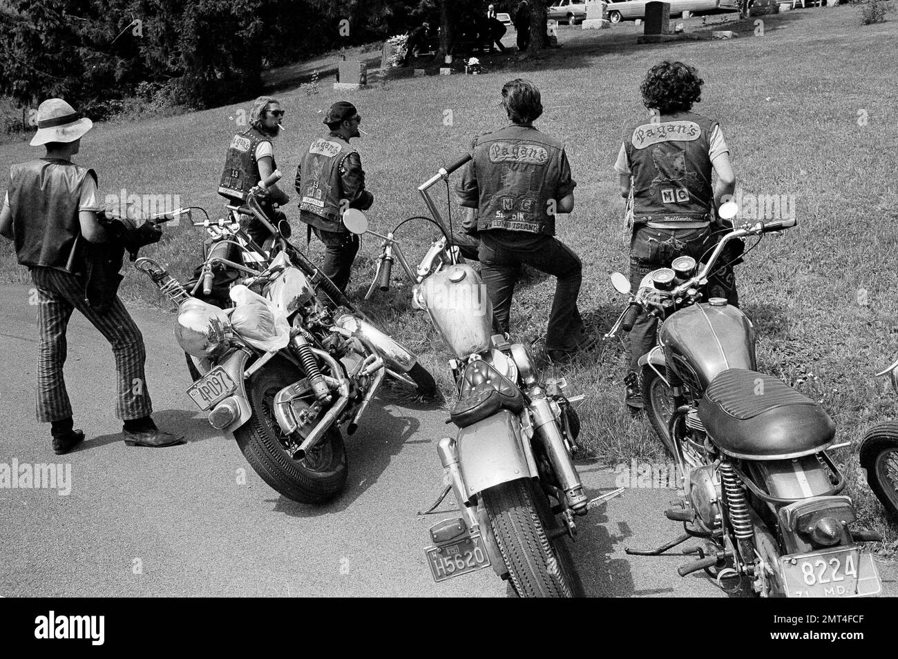 Members of the Pagan's Motorcycle Club wait for priest to conclude his ...