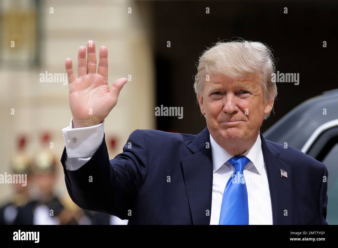 US President Donald Trump waves as he arrives for a meeting with French ...