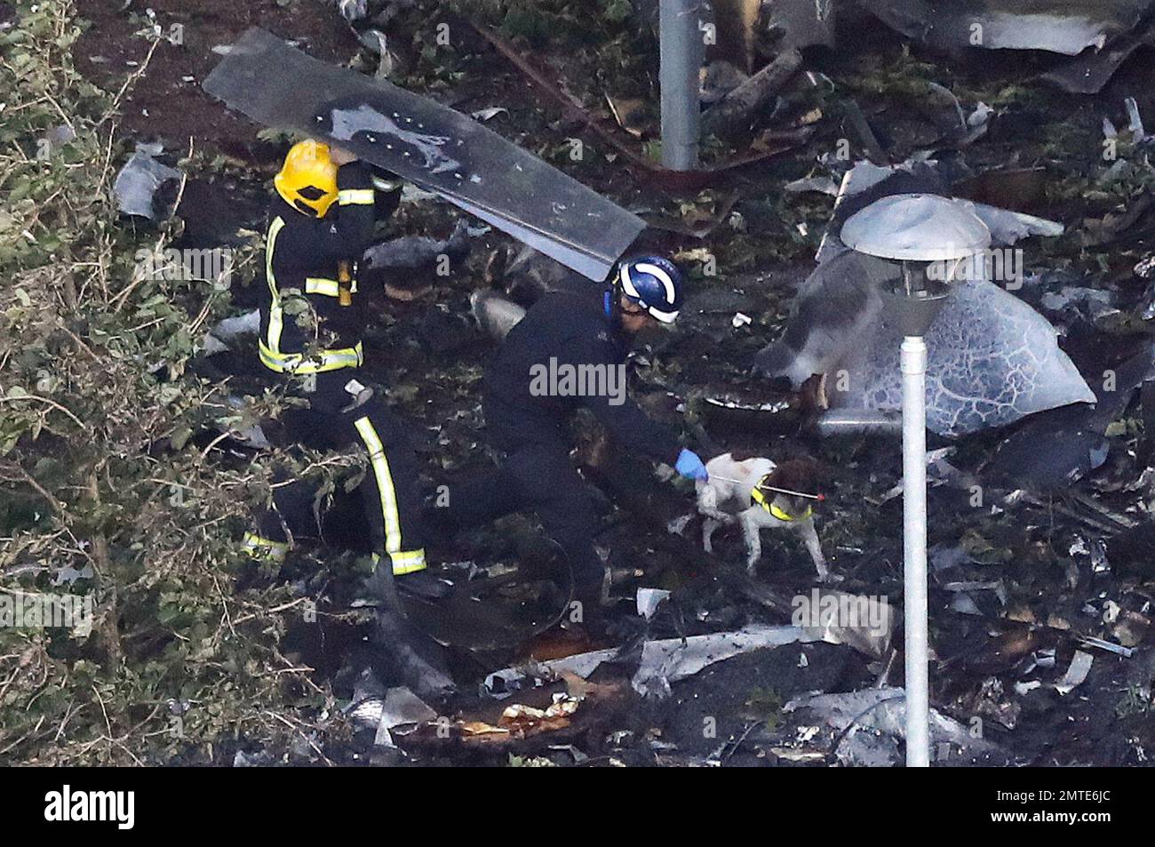 Firemen search the debris of the Grenfell Tower in London as ...