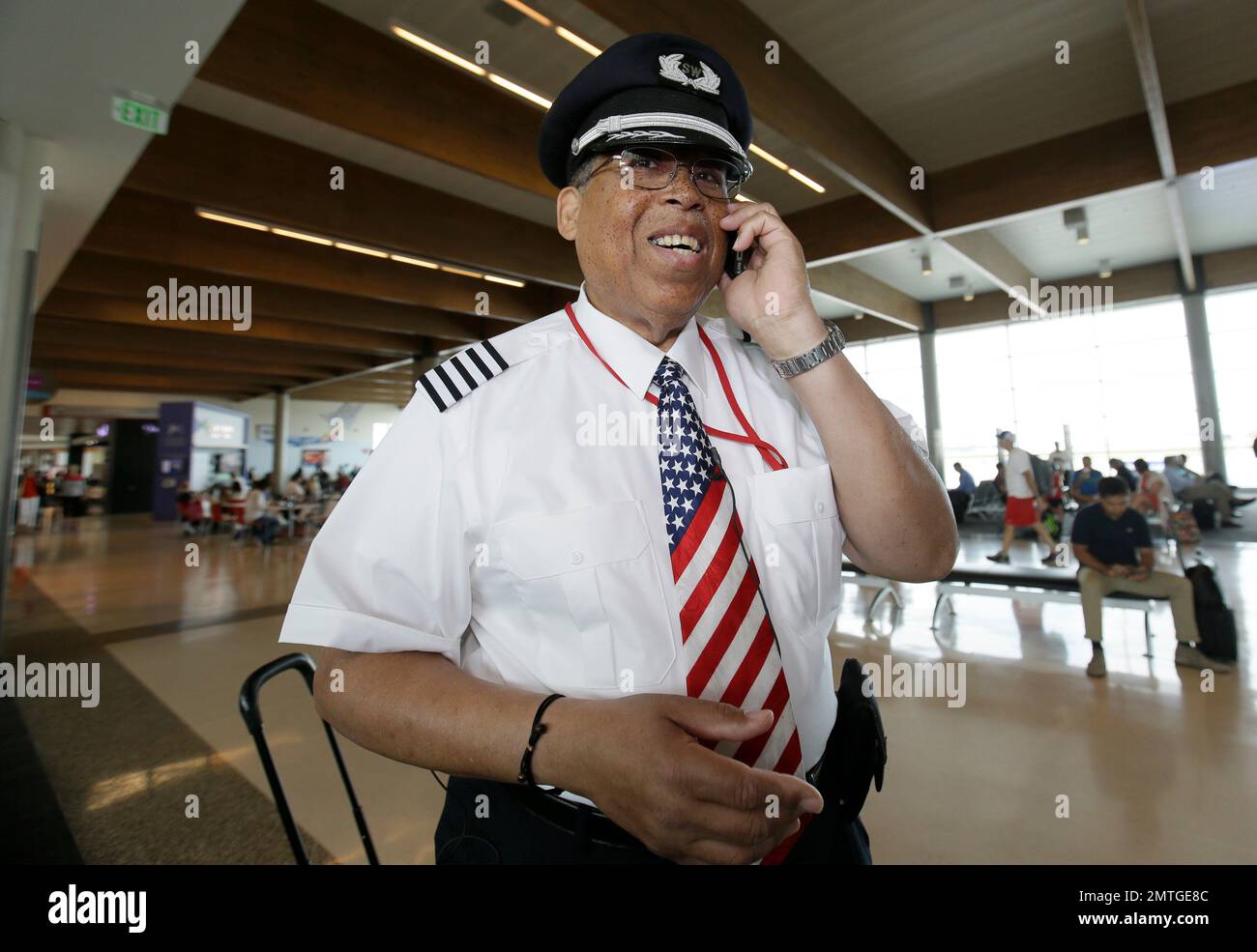 Southwest Airlines captain Louis Freeman talks on a cell phone as he ...