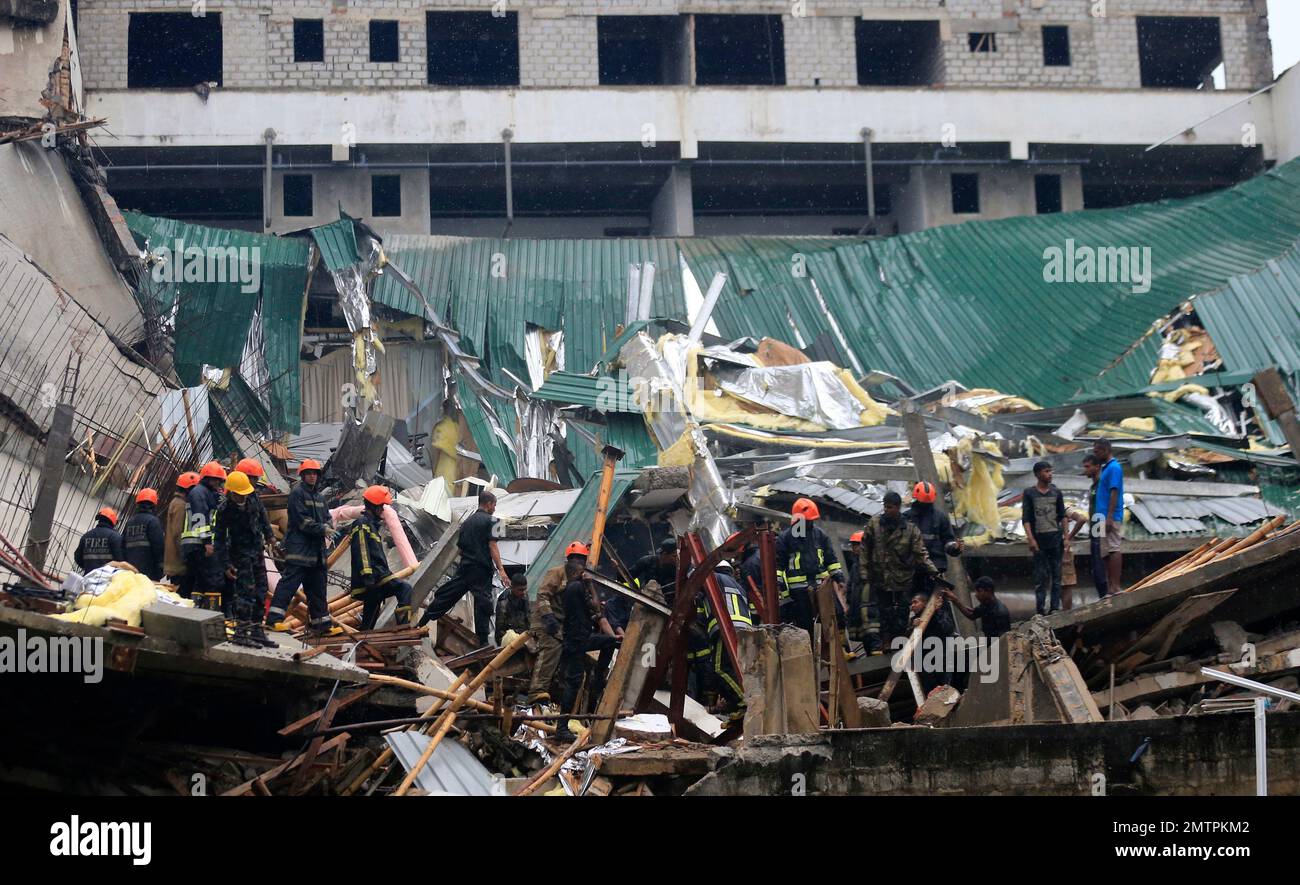 Sri Lankan military rescuers and fire fighters search for trapped ...
