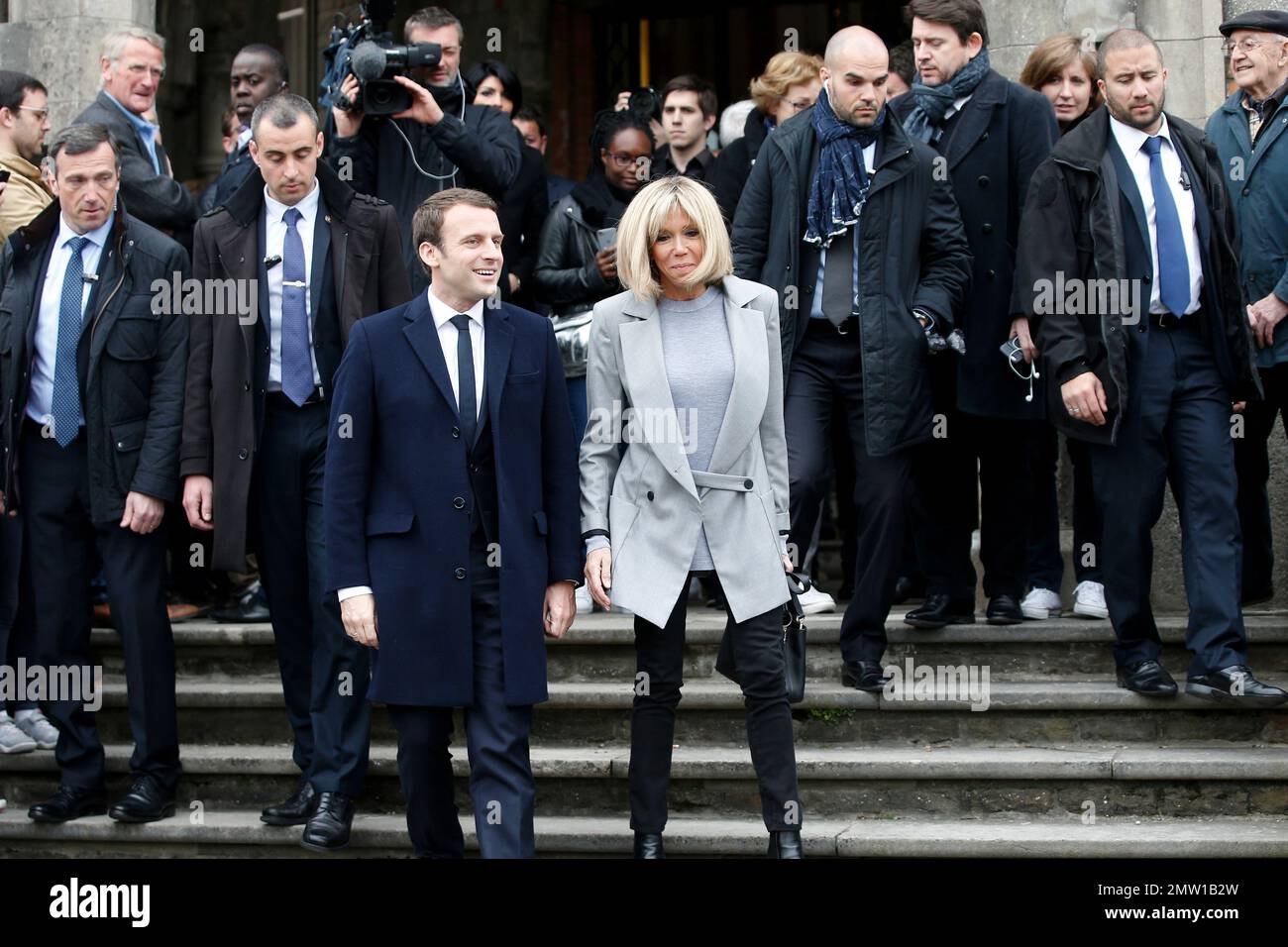 Centrist candidate Emmanuel Macron and his wife Brigitte leave after ...