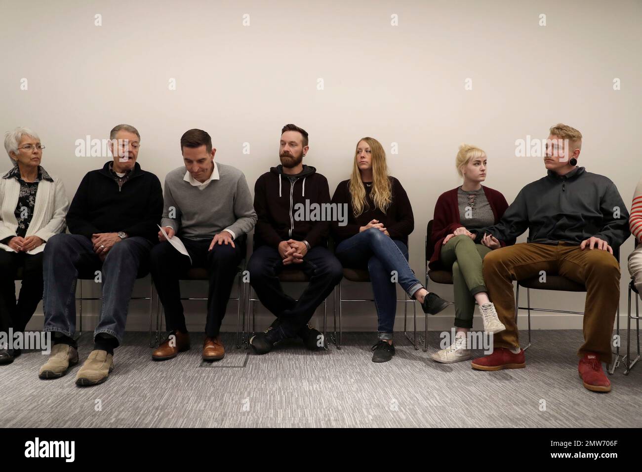 Clint Payne, third left, gets up to speak, flanked by family members of ...