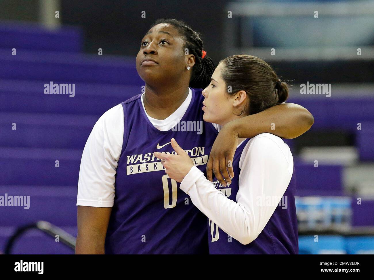 Washington's Chantel Osahor, left, throws her arm around Kelsey Plum as ...