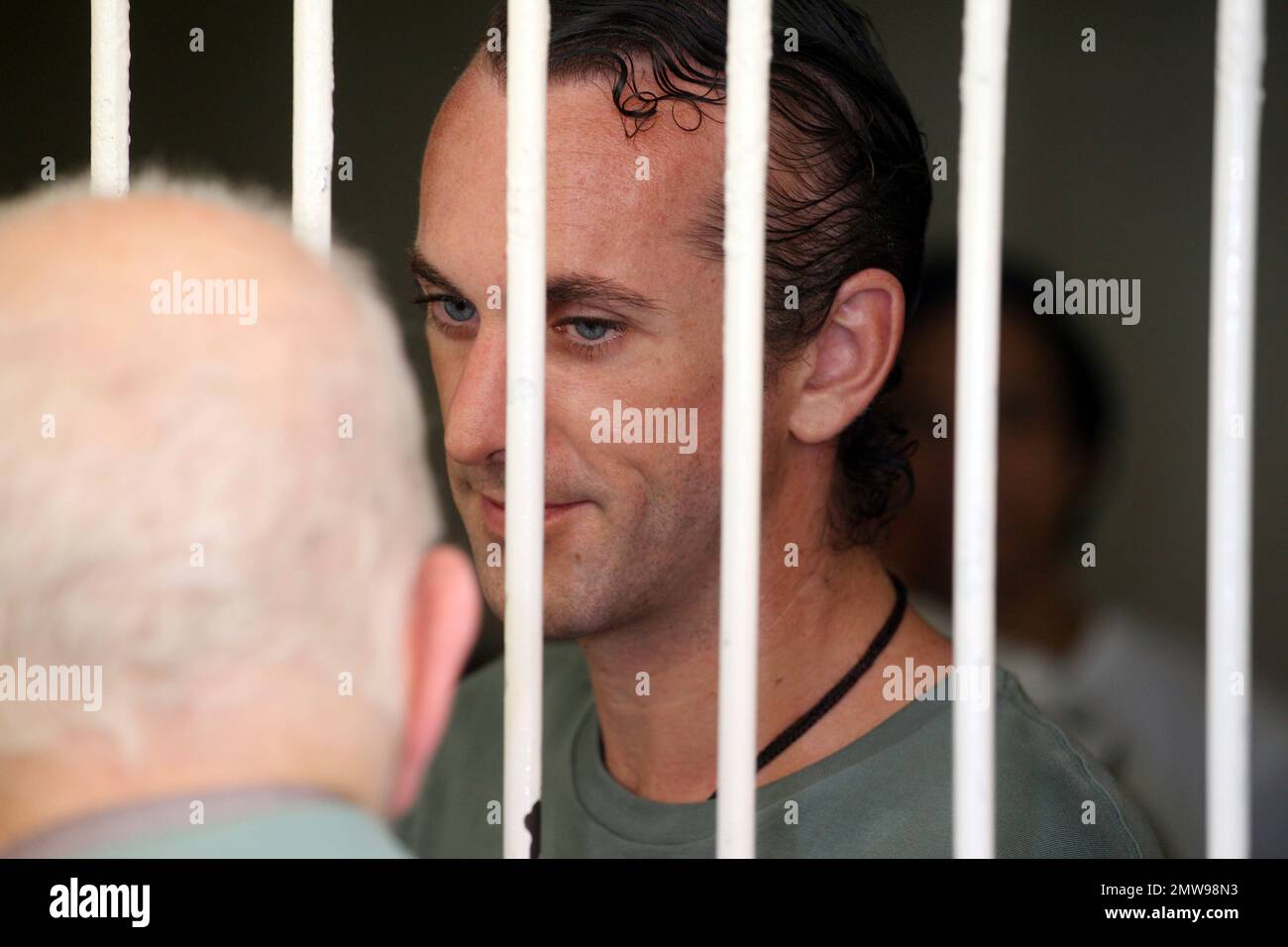 British national David Taylor, right, in a holding cell talks to his ...