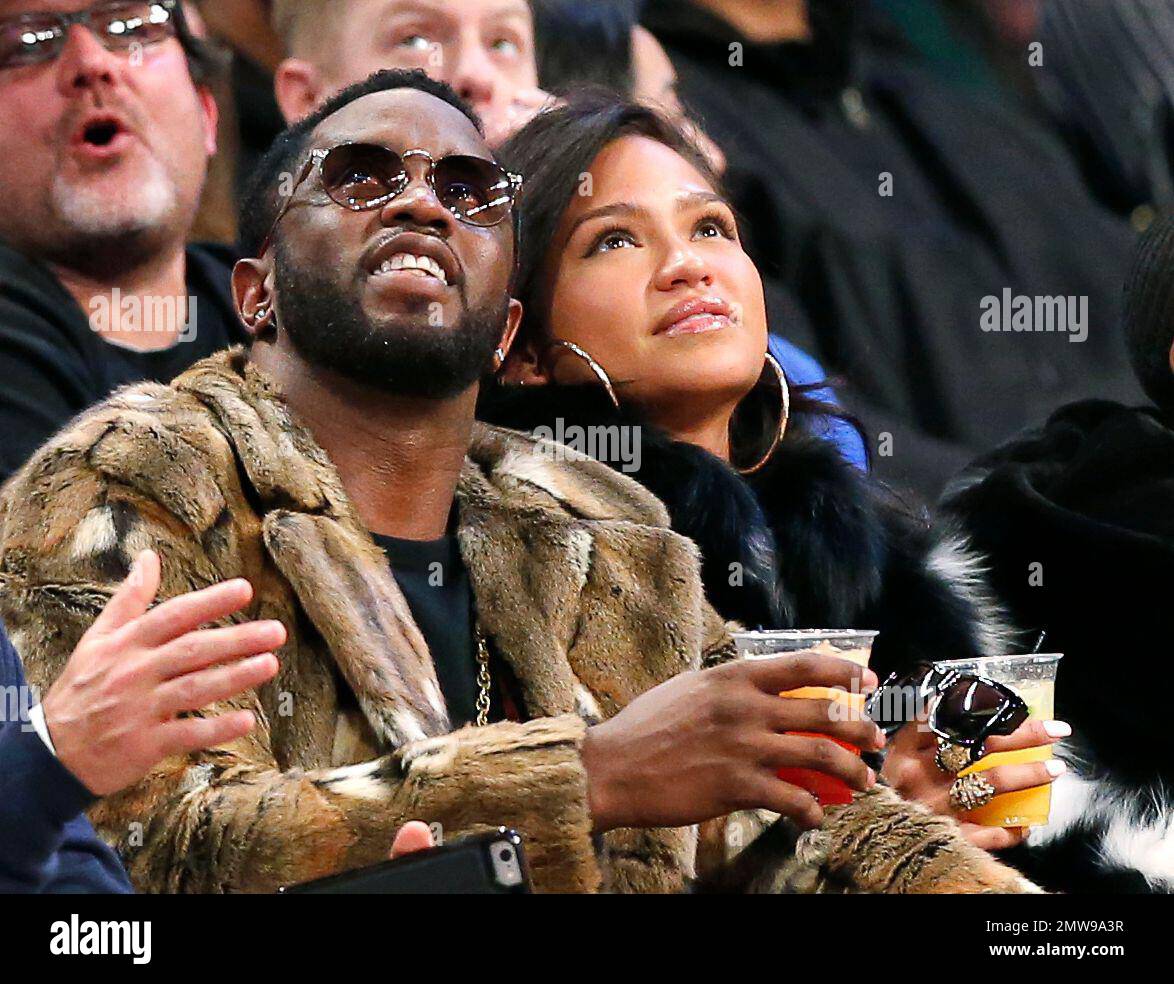 Sean "Diddy" Combs, left, sits beside Cassie as they watch a giant ...