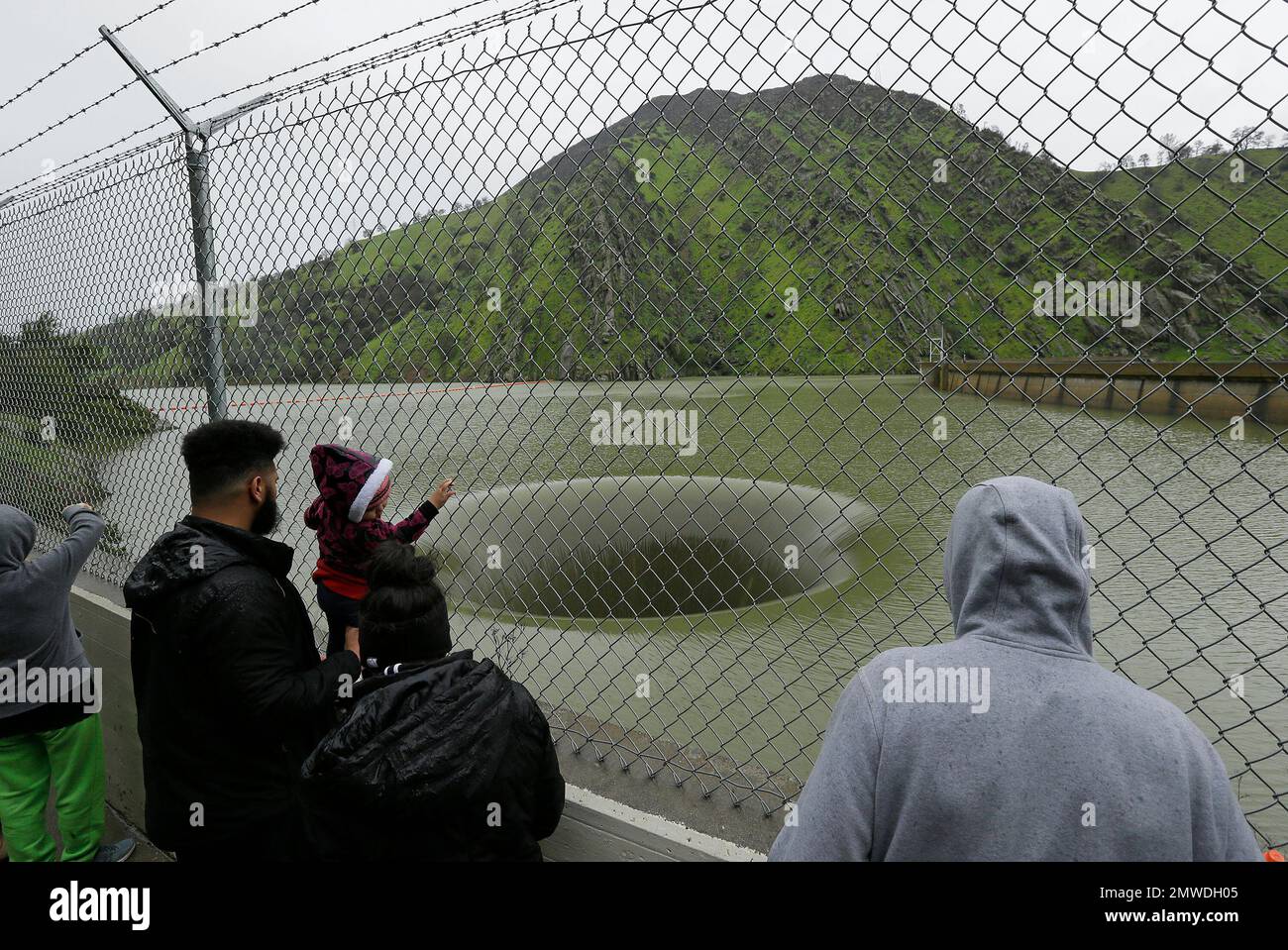 People stop to watch water flow into the iconic Glory Hole spillway at ...