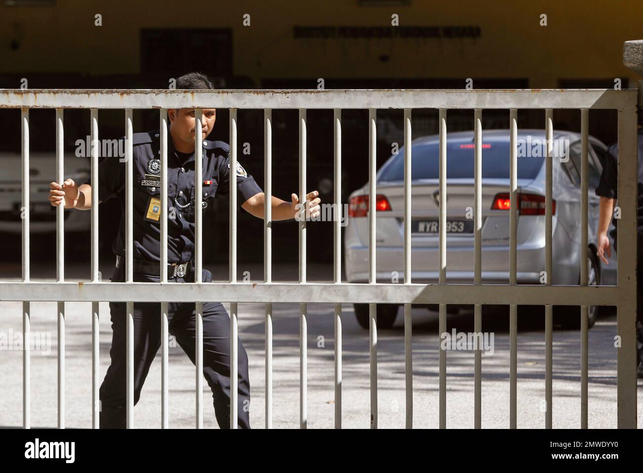 A police officer closes the main gate to the forensic department at ...