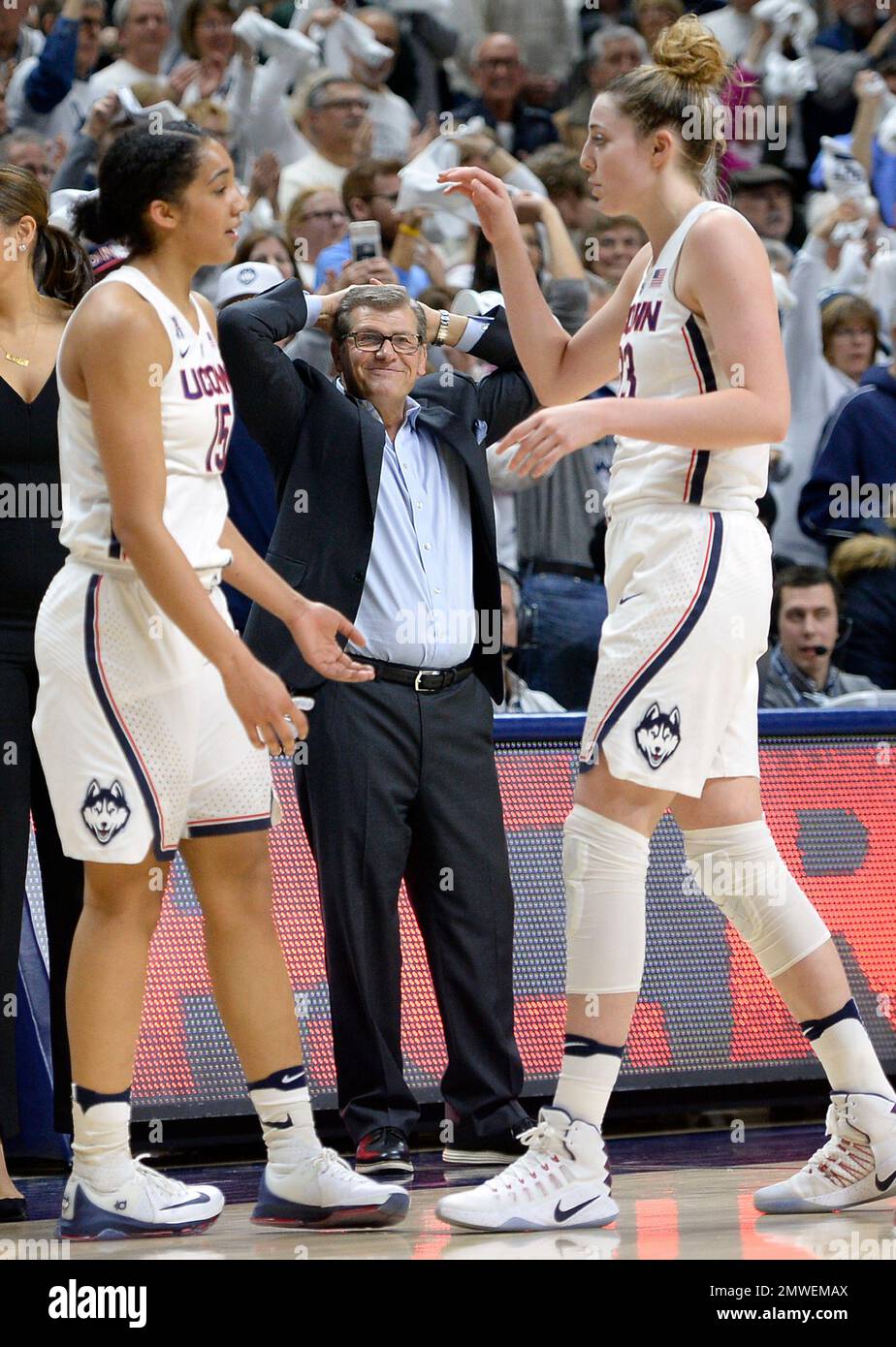 Connecticut head coach Geno Auriemma smiles as he looks at players ...