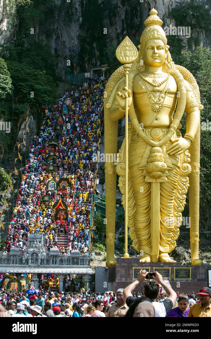 Hindu devotees walk up the 272 steps of the Batu Caves temple as part ...