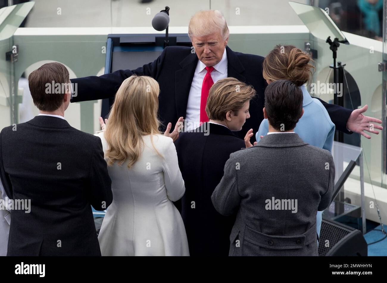 Donald Trump is embraces his family after being sworn in as the 45th ...