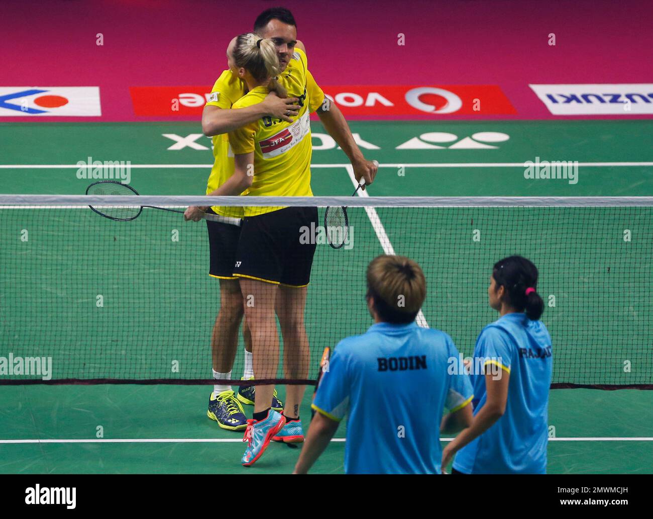 British badminton players Gabrielle Adcock, top right, hugs teammate ...