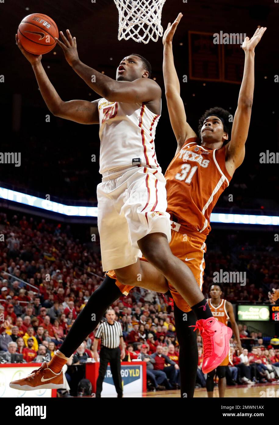 Iowa State guard Deonte Burton drives to the basket past Texas forward ...