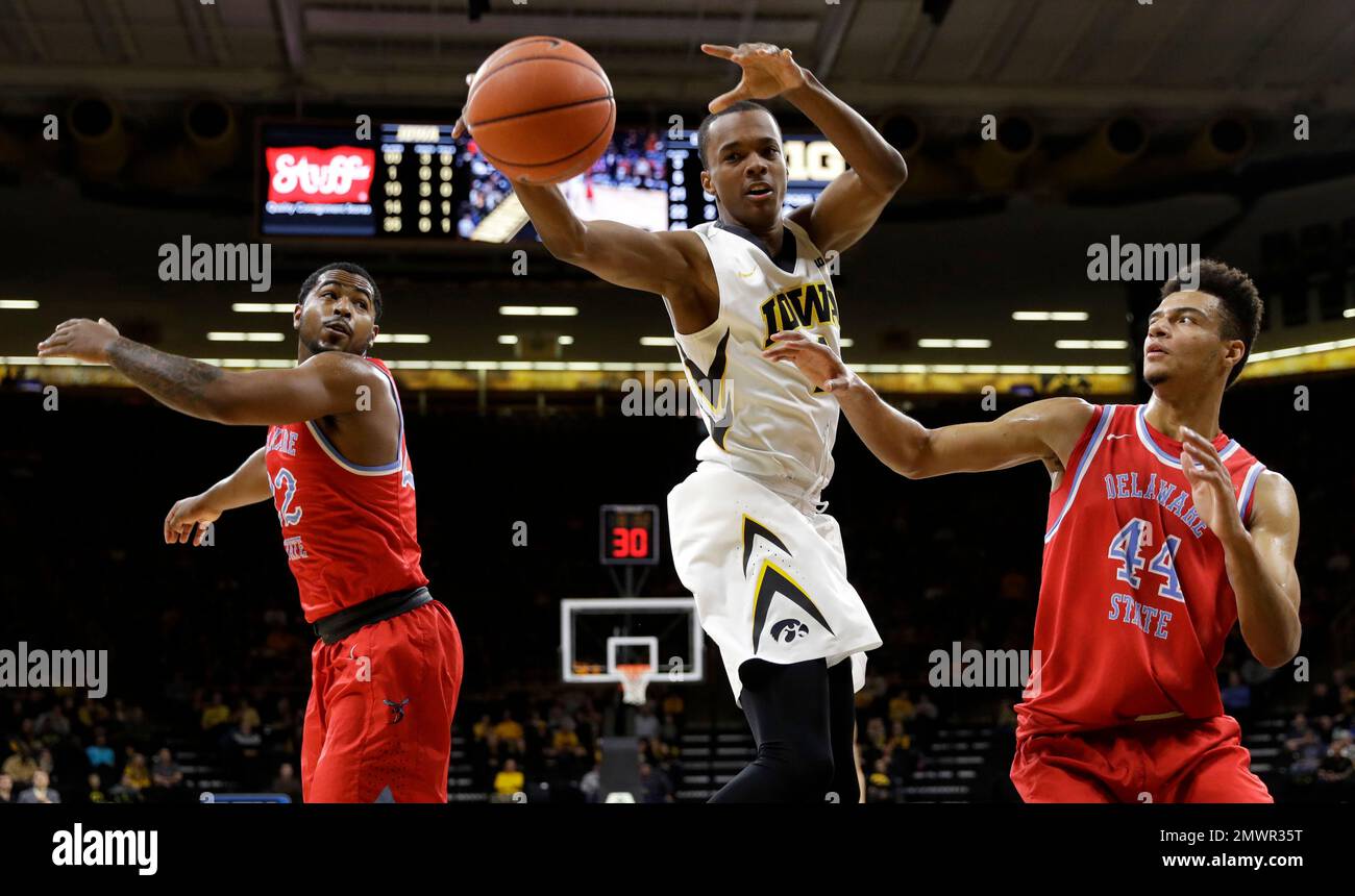 Iowa guard Maishe Dailey, center, reaches for a rebound between ...