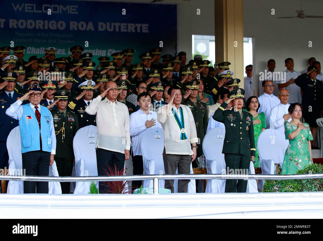 Philippine President Rodrigo Duterte, center, salutes with, from left ...