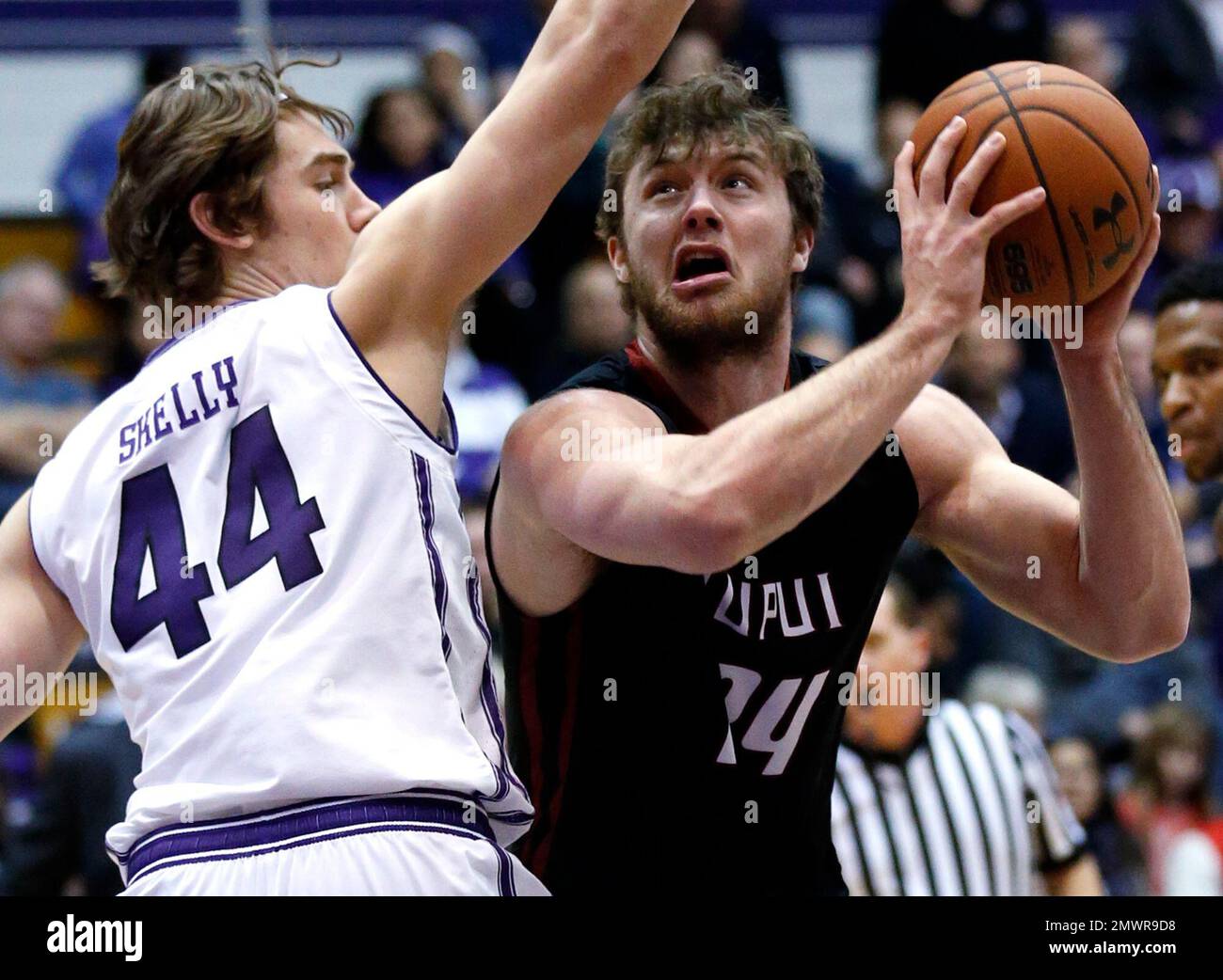 IUPUI forward Evan Hall, right, looks to the basket as Northwestern ...