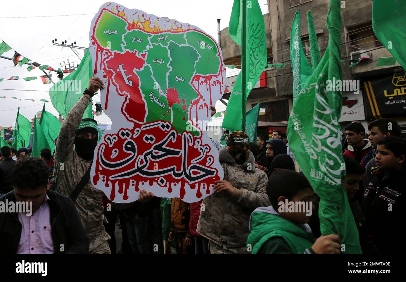Masked Palestinian militants from the Izzedine al-Qassam Brigades, a ...