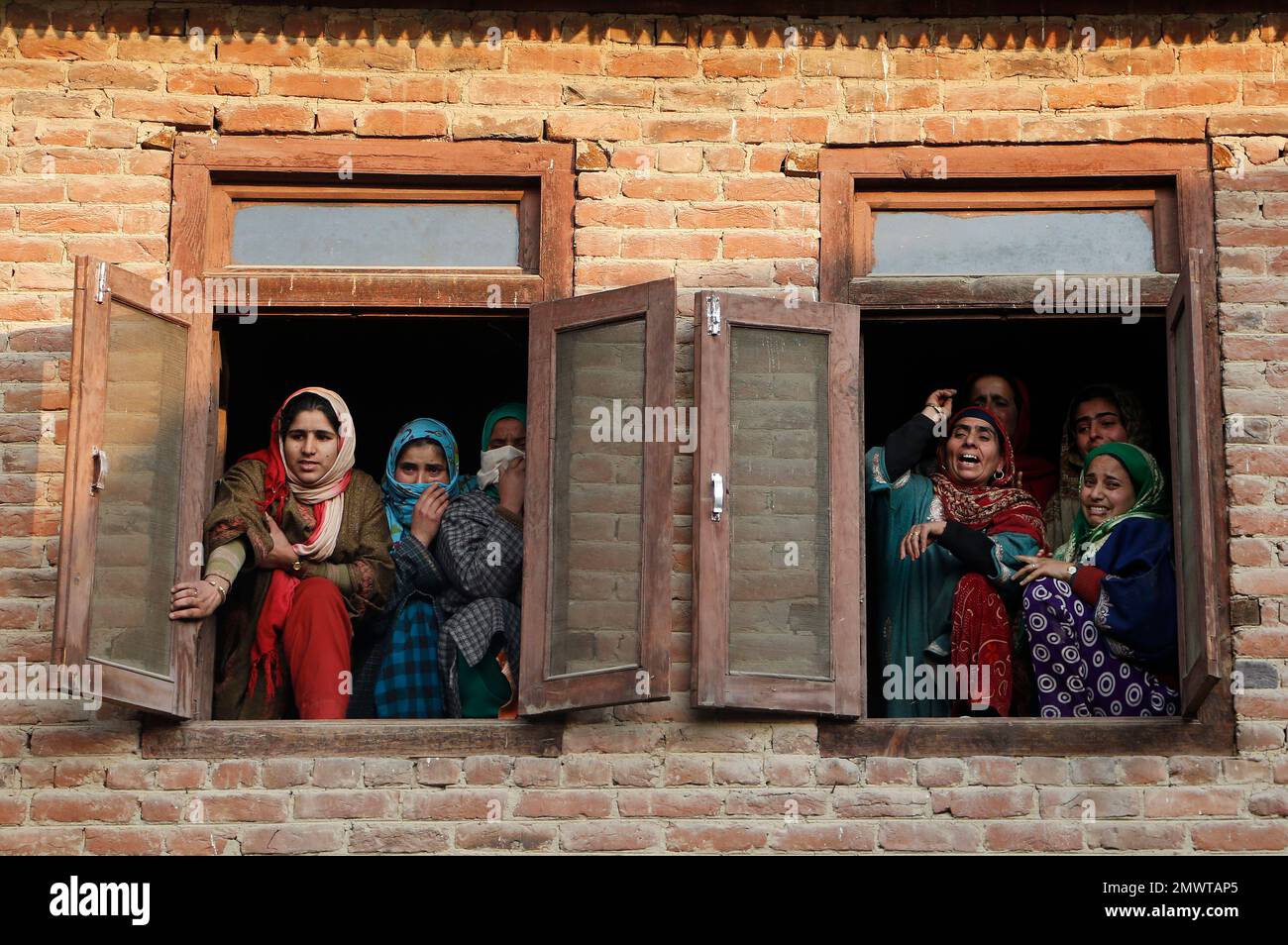 Kashmiri Muslim women watch funeral procession of Basit Ahmad Dar, a ...