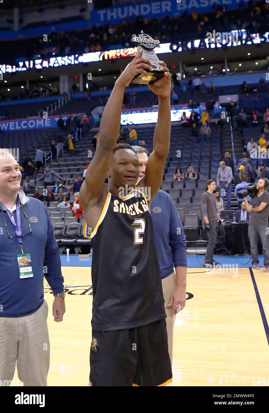 Wichita State guard Daishon Smith (2) holds up the Outstanding Player ...