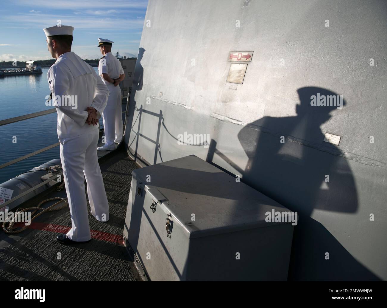 Navy sailor aboard the USS Halsey stand at parade rest as the ship ...
