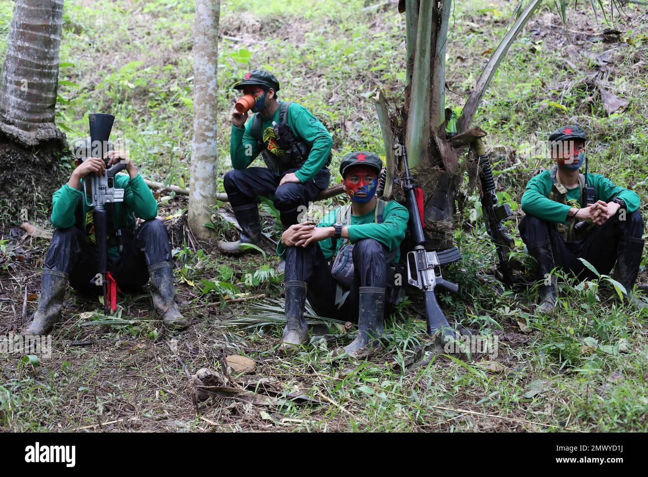 In this Nov. 23, 2016 photo, New People's Army guerrillas with face ...