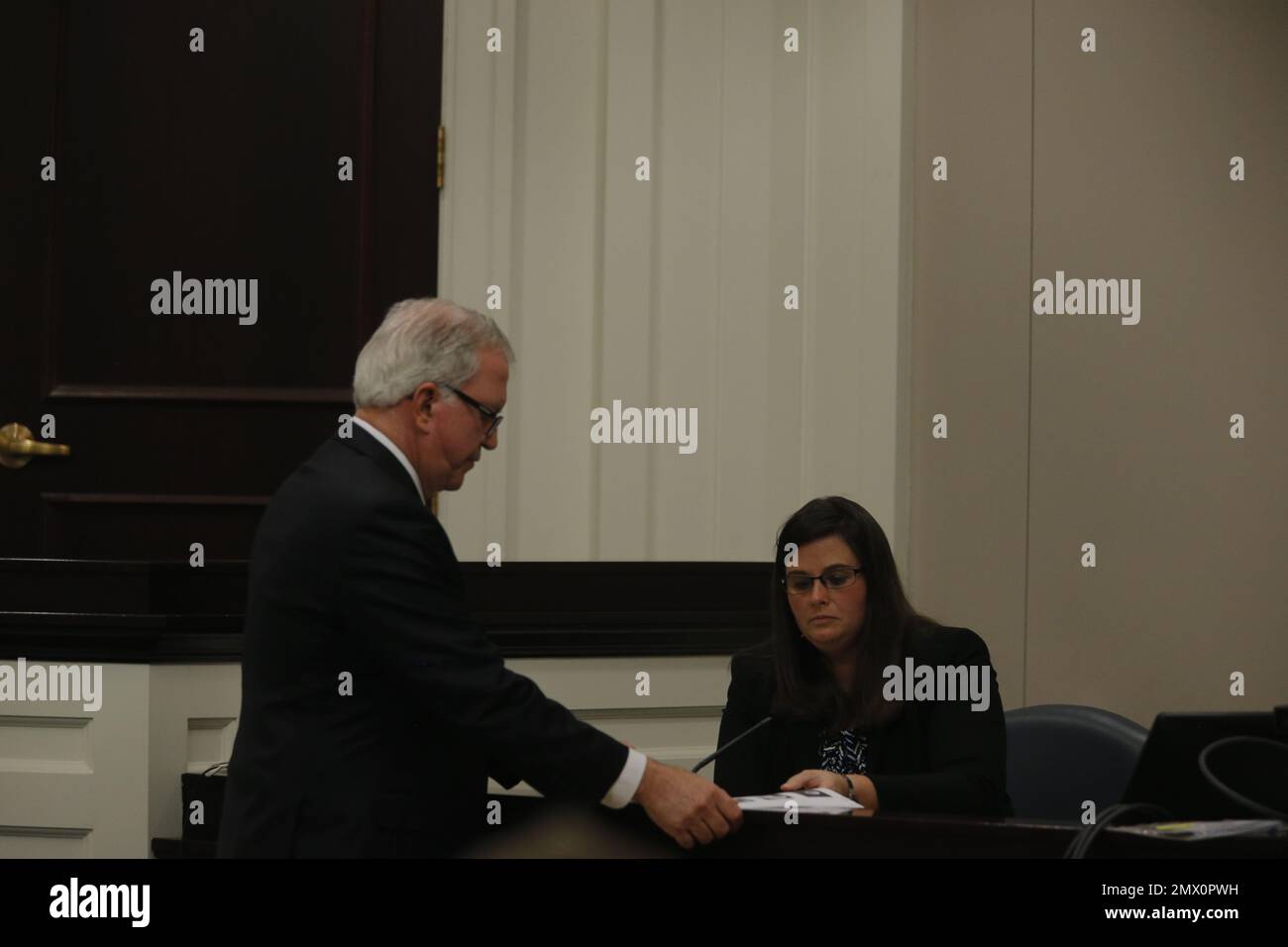 Defense attorney Andy Savage, hands documents to State Law Enforcement ...